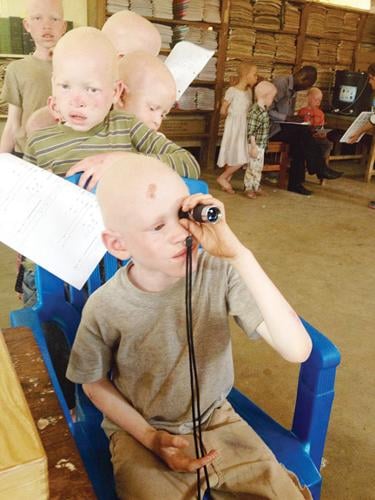Dr. Ashley Risner helps children with albinism with their vision during ...