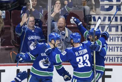 Sedin twins combine on OT winner over Coyotes in their final home game ...