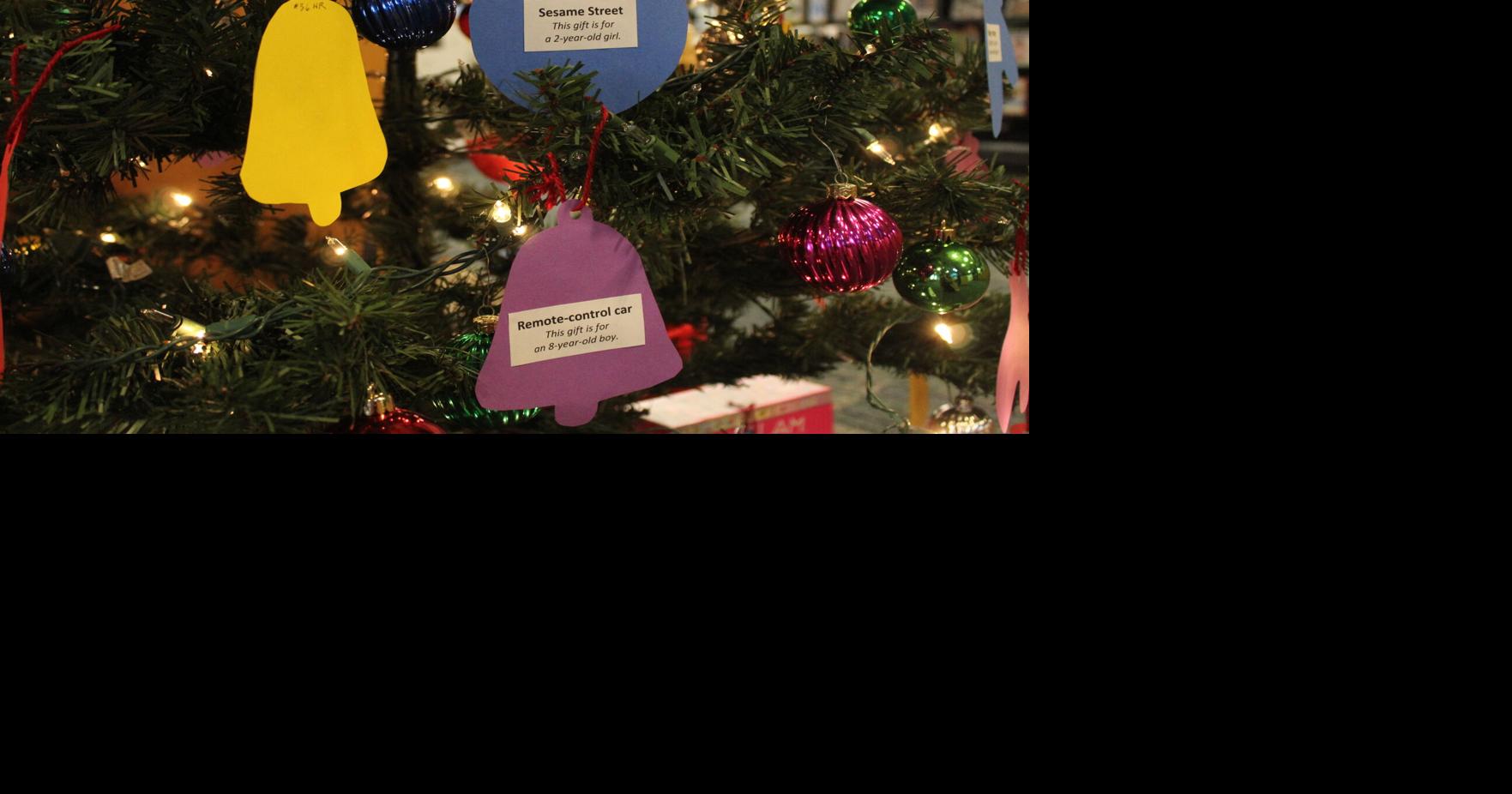 Children's librarian Anne Goddard creates ornament tags that list wish ...