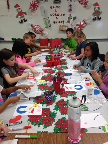 Power Ranch students write hundreds of holiday cards for troops ...