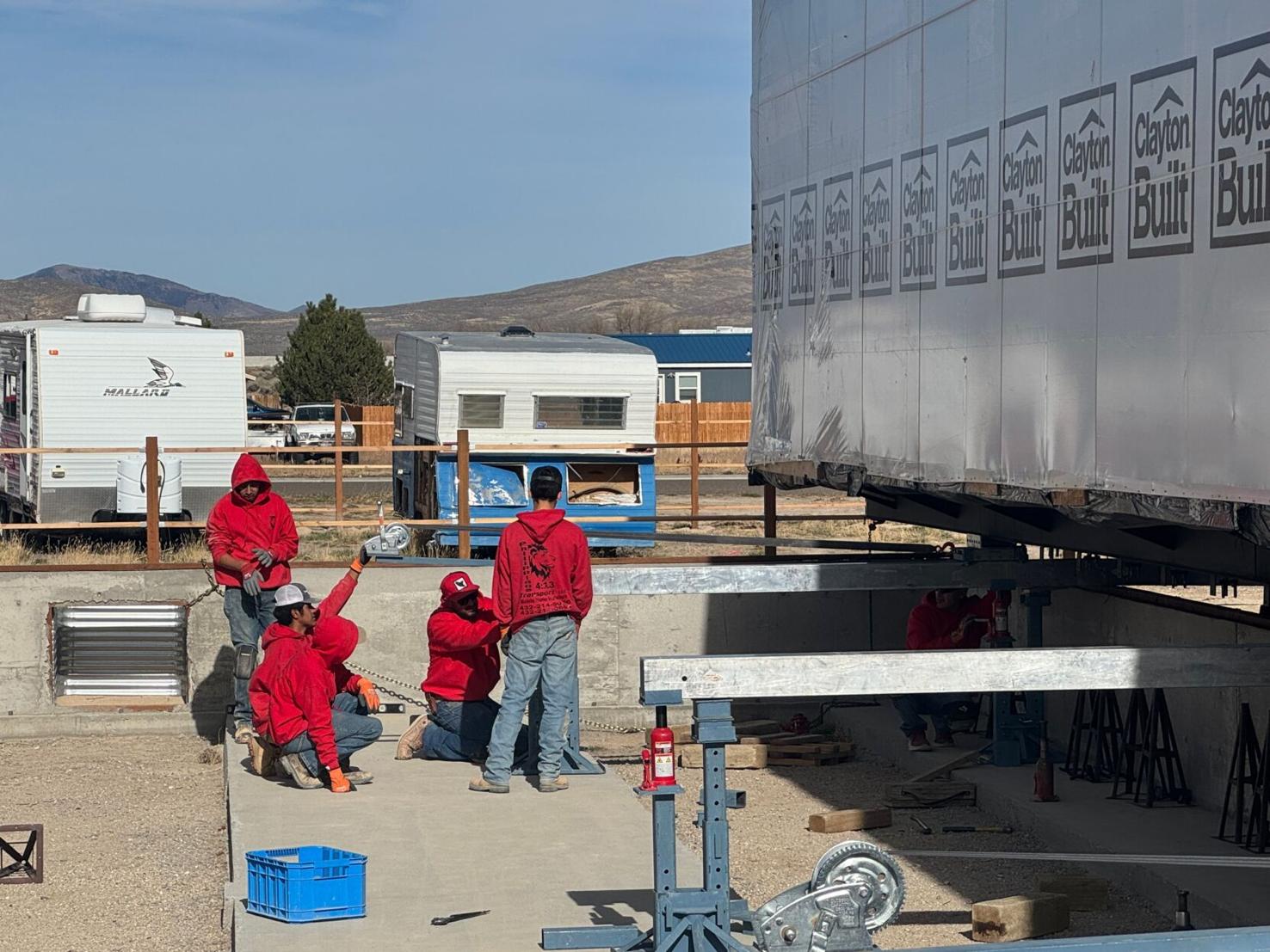Workers move 1st home in place for planned Wells development