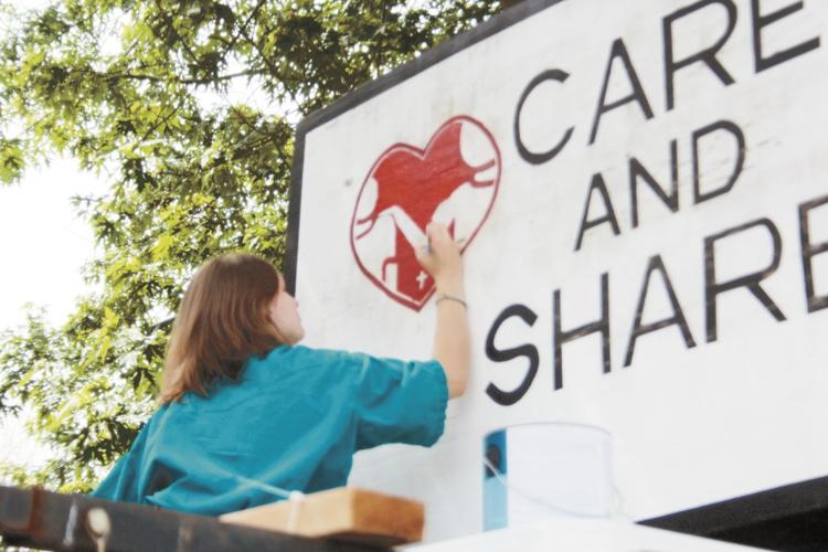 UCHS student gives Care and Share sign a touch-up | Education ...