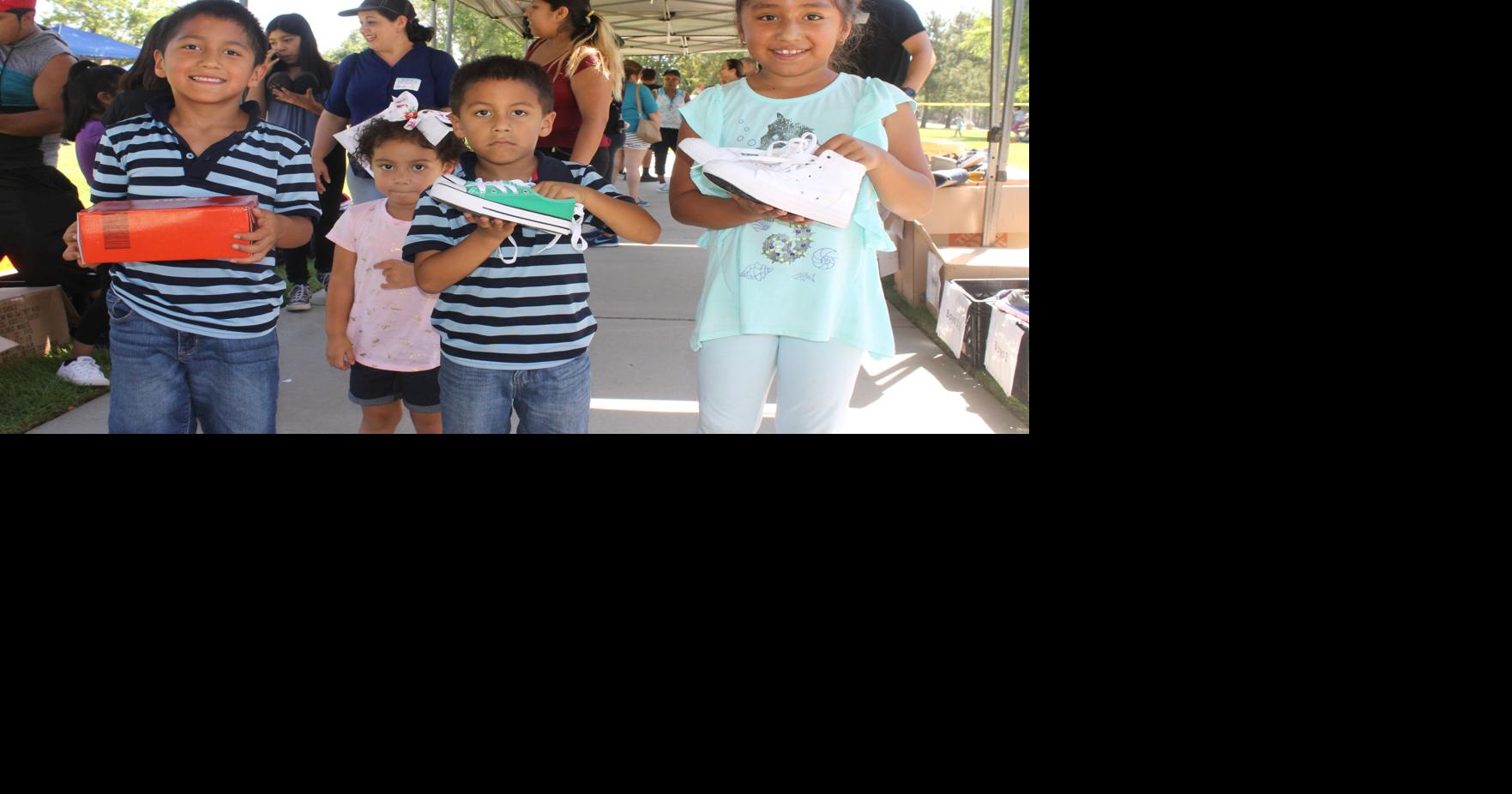 Hundreds of students receive free backpacks and shoes during event at ...