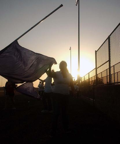 Practicing flag routines in the setting sun. | Sports ...