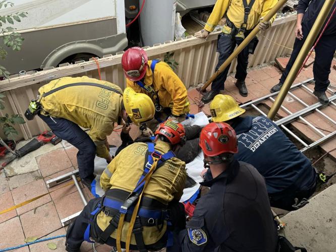 Woman is rescued after falling 25 feet to the bottom of old septic tank in her Fontana yard ...