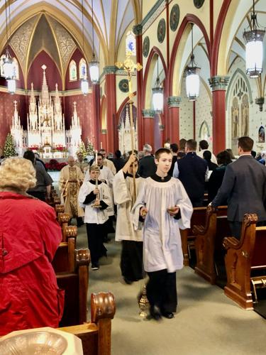 Families gather at Holy Family Cathedral to celebrate Christmas Day ...