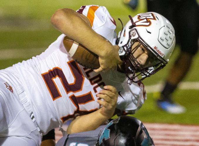 High school football: Daniels shares the spoils with teammates as ...