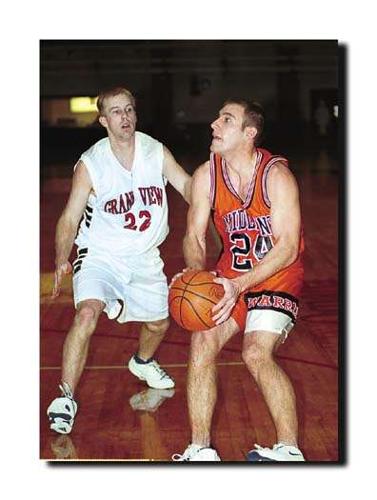 Luke Worth, right, of Midland Lutheran College pulls up for a shot ...