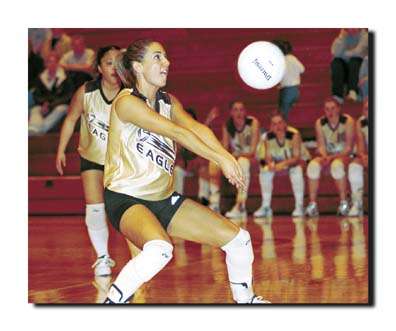 Ashley Russell of Arlington bumps a pass while teammate Jen Worth looks ...