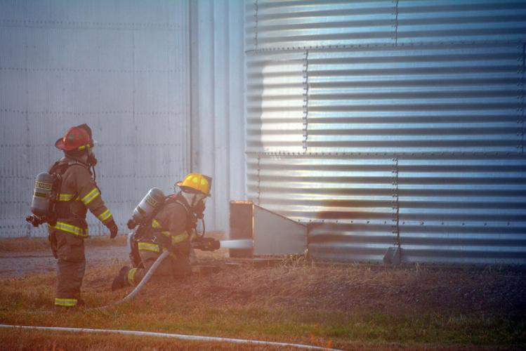 Firefighters battle grain bin fire