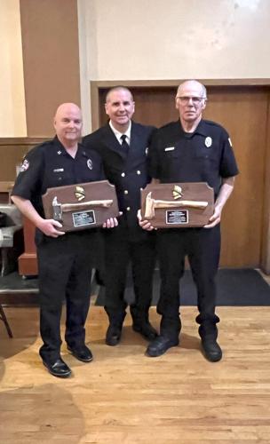 Tim Kraack (left) and Bob Goodson (right) stand with Chief Michael ...