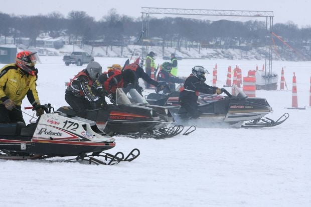 Snowmobiles run on Clear Lake