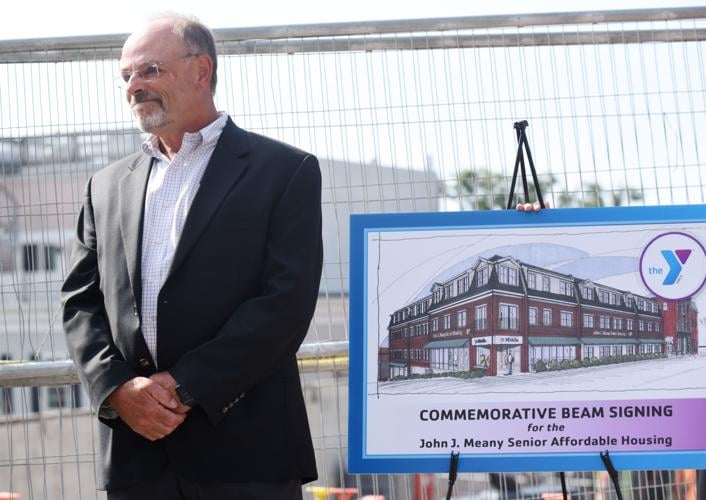 Affordable housing beam signing honors past Y CEO | Business ...