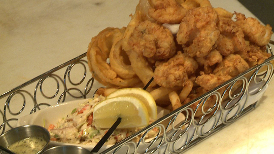 Traditional New England fish fry Cod cheeks, onion rings and thin fries ...