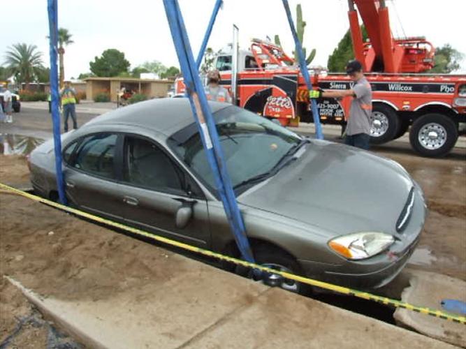 Car hits hydrant, slowly sinks before crane pulls it out | Local News ...