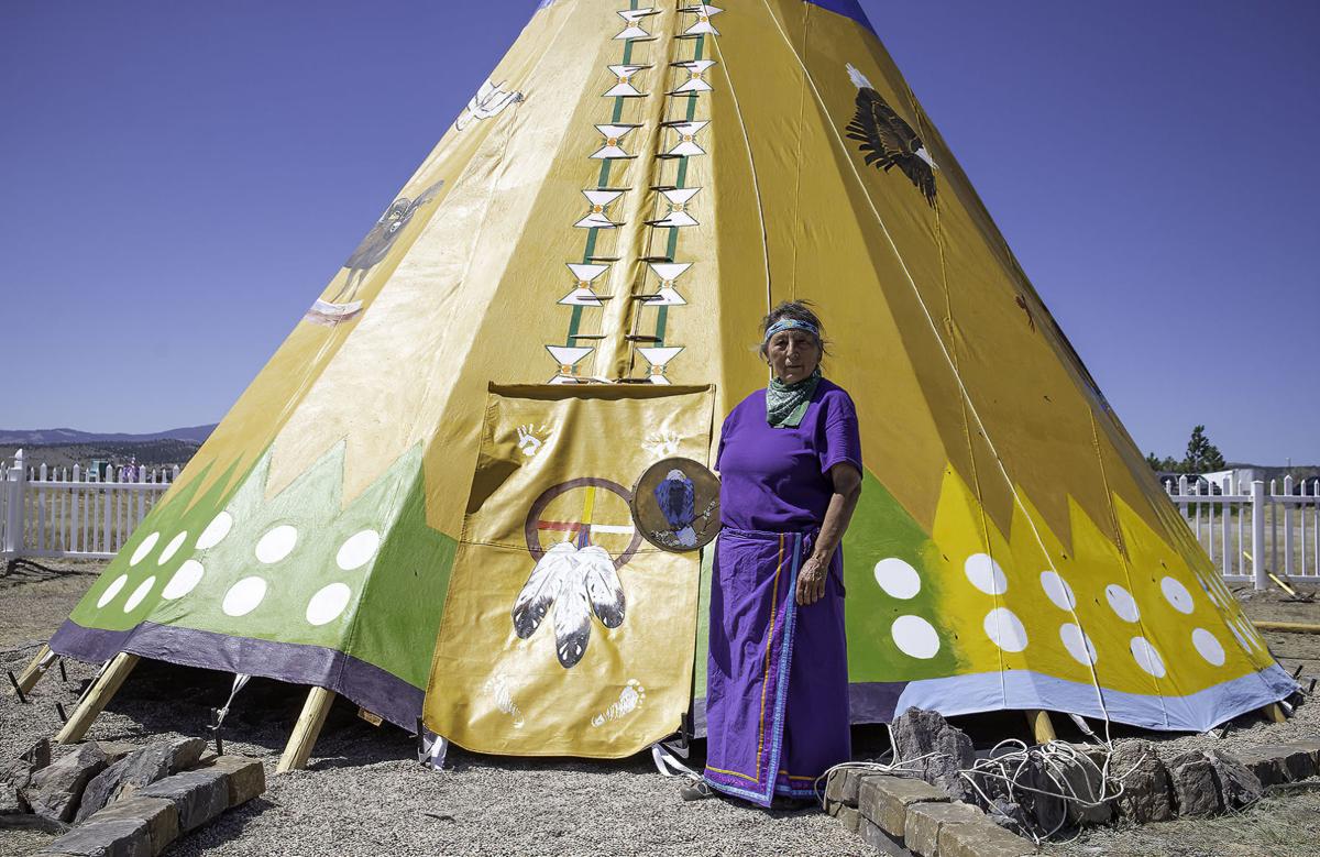 Local artist and tribal elder paints teepee for Helena Valley family
