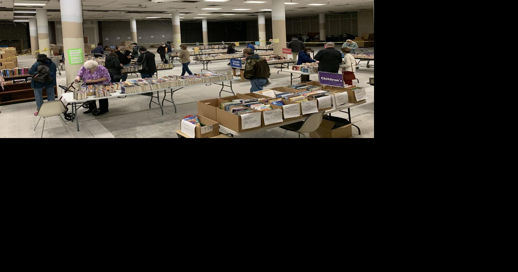 Readers fill their carts at Decatur library's used book sale