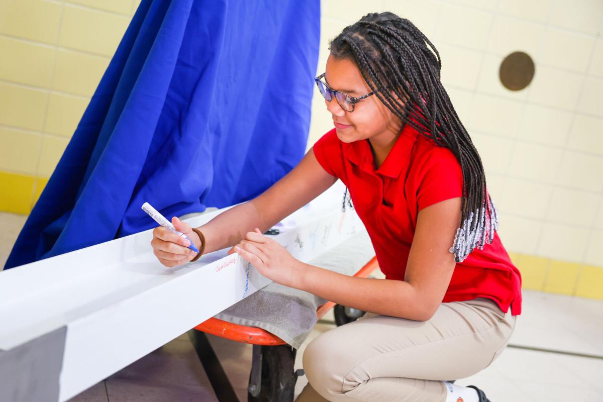 Decatur students sign a Dansby Magnet School beam