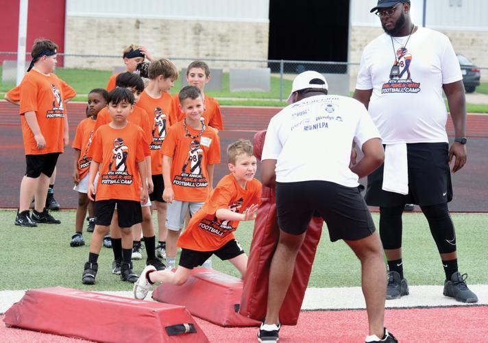 Pro football player John Franklin-Myers conducts football camp in ...