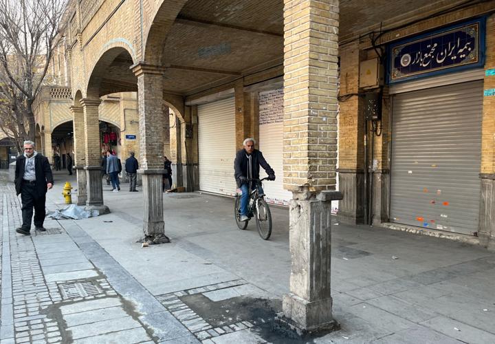 Security forces clash with protesters in Iran's main market as at least ...