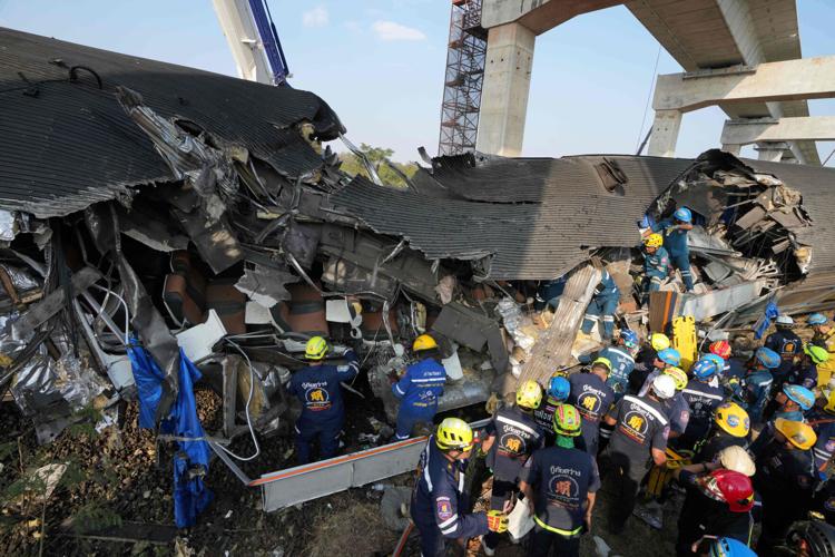 Photos show rescue workers at scene of crane collapse and train ...