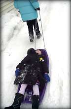 Andrea Slattery, 7, gets a ride home from her sister Jasmine, 10 ...