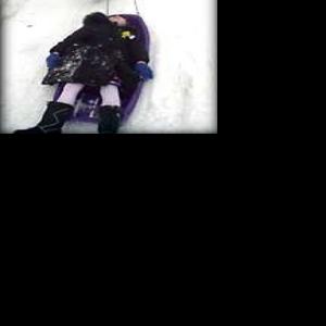 Andrea Slattery, 7, gets a ride home from her sister Jasmine, 10 ...