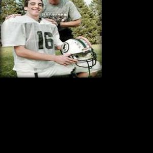 Terry Manning, a former fullback at Hartford, poses with his son Brad ...