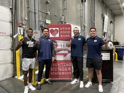 USU football players help deliver 35,000 pounds of pork to Utah Food ...