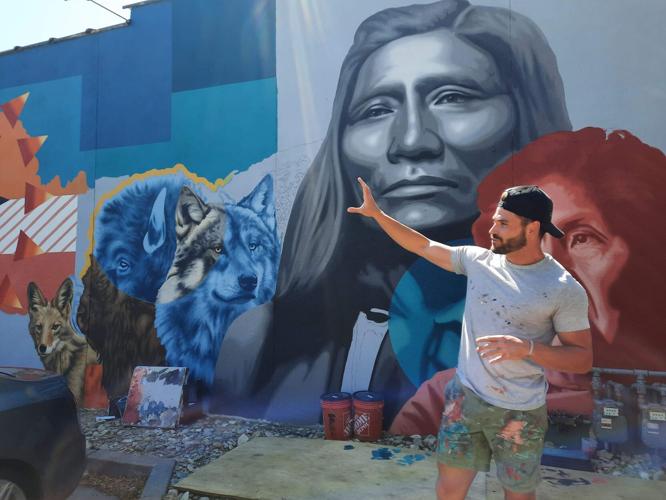 Artist tells the story of near finished mural on Logan Main Street ...