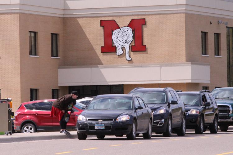 MHS students pick up caps and gowns, 2020 yearbooks | Free ...