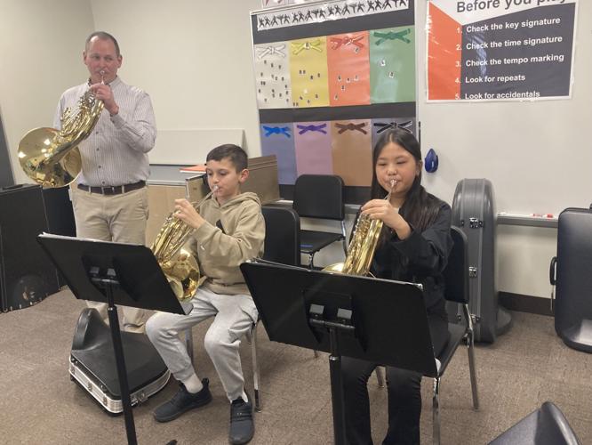 Fifth-grade band educator teaches students first instruments ...