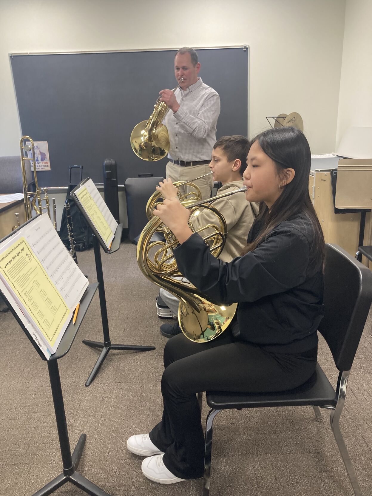 Fifth-grade band educator teaches students first instruments ...