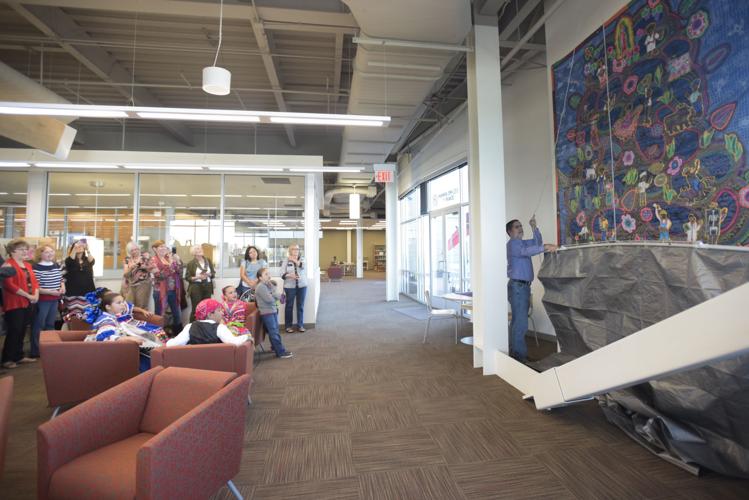 Nampa Public Library unveils "tarpage" art in Spanish-laguage section ...