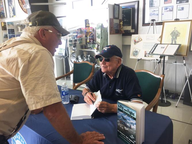 WWII triple ace dogfight pilot signs books at the Warbird Roundup 2018 ...