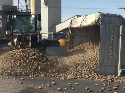 Truck topples over near J.R. Simplot Don Plant spilling potatoes onto ...