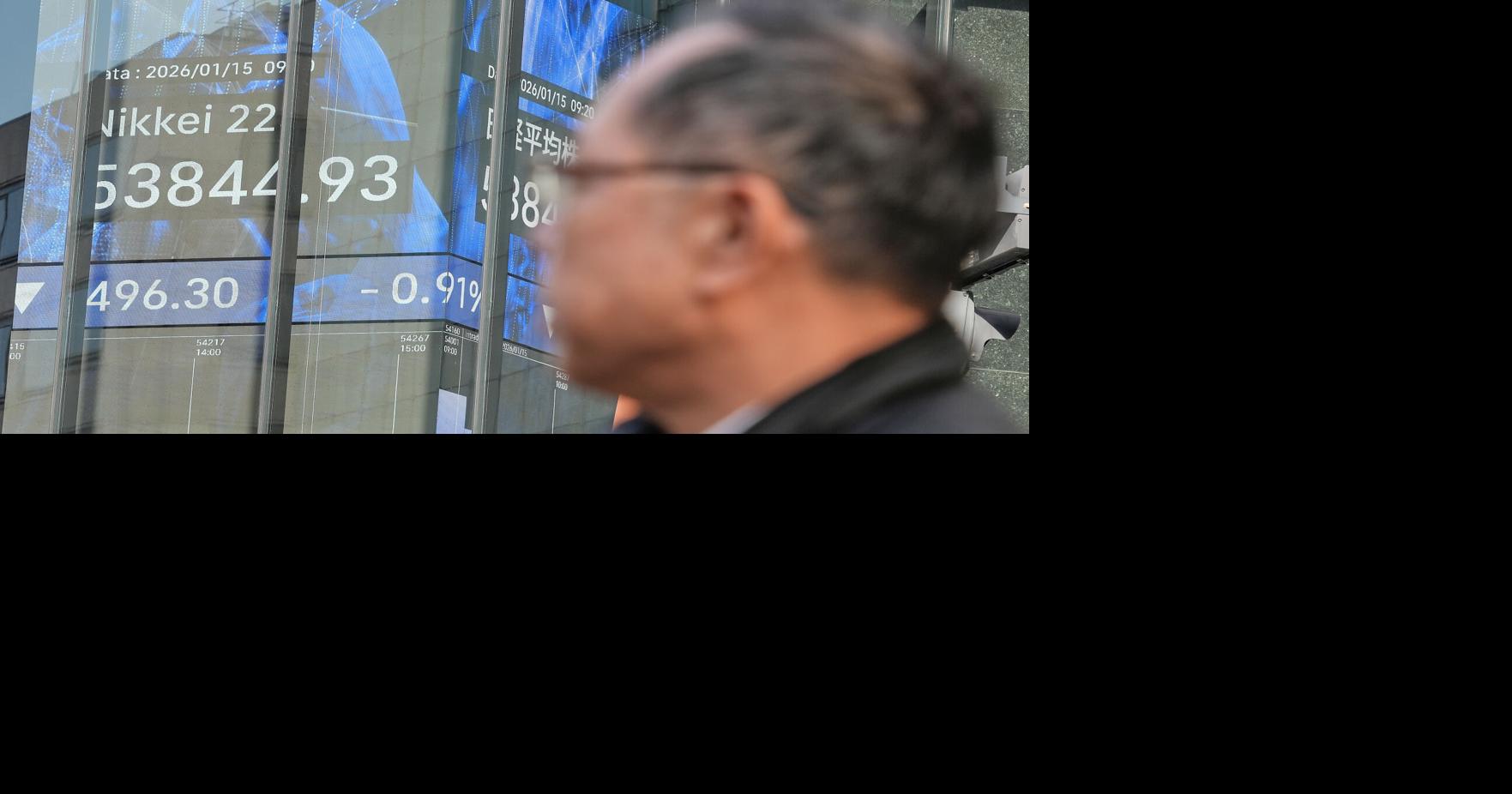 US futures slip and world shares are mixed as Japan keeps its key ...