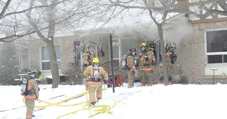 Firefighters battle a townhouse fire in Burlington, forces evacuation ...