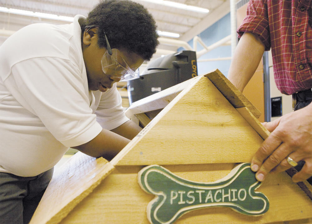 Students learning life skills with woodworking