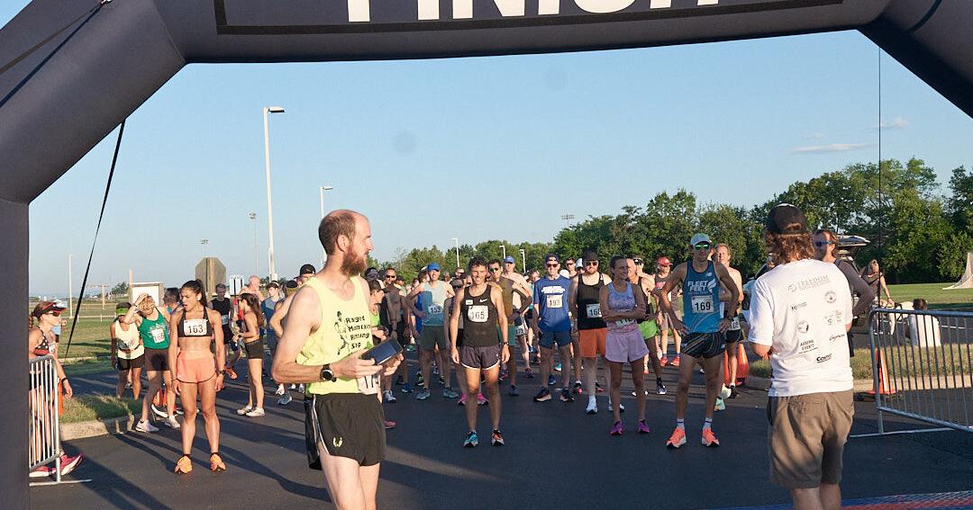 Chris Koehler (R) gives instructions to the field of runners.jpg ...