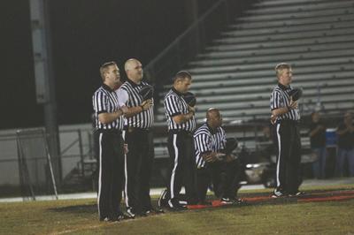 Football official kneels during National Anthem at Southwest game ...