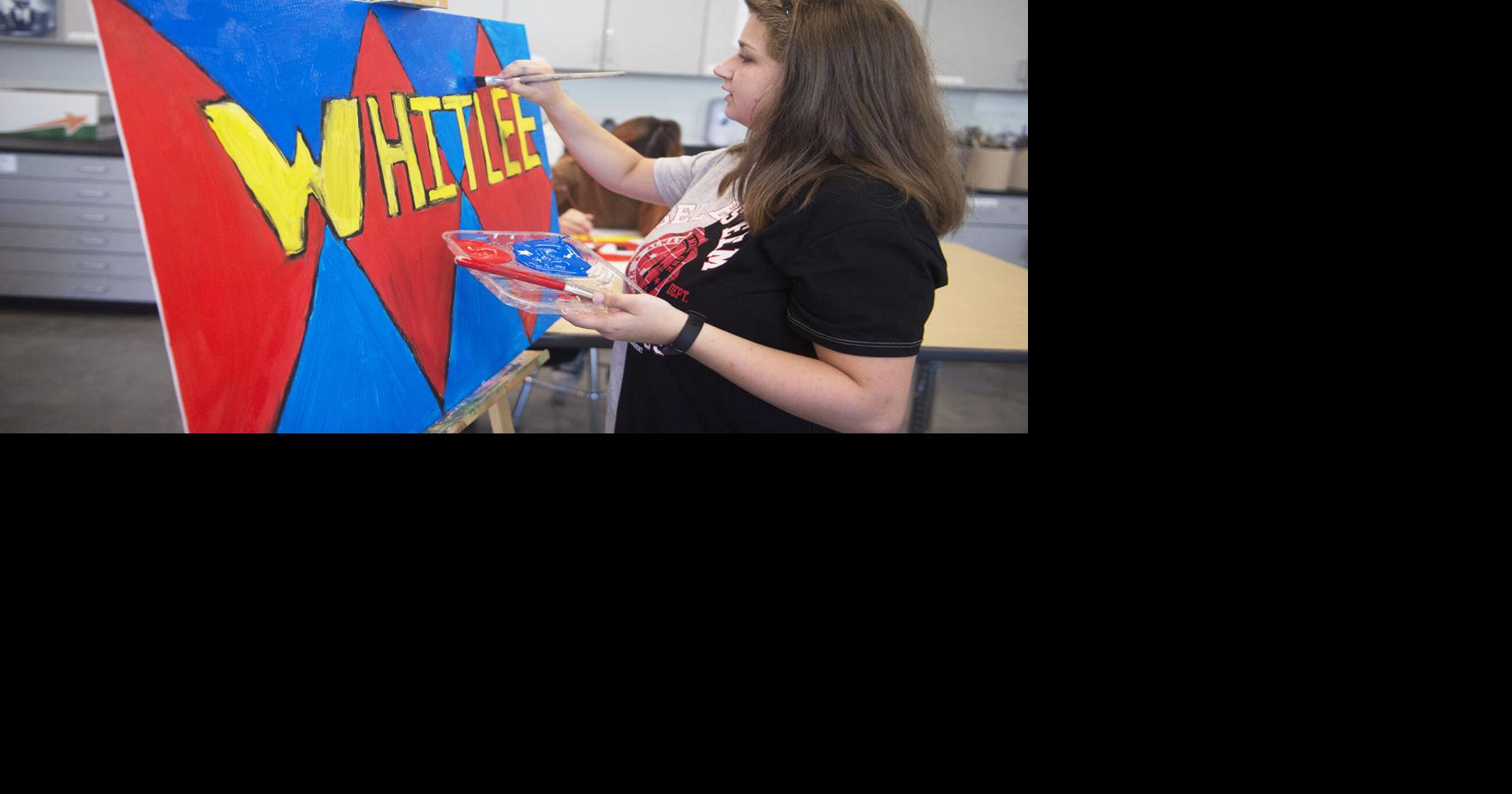 Painting students creating signs for music festival performers | Local ...