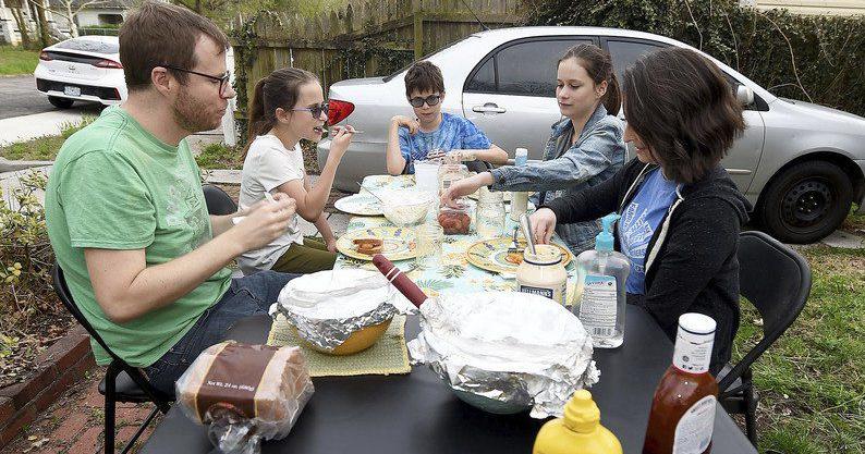 Neighbors maintain social distance while dining on driveways ...