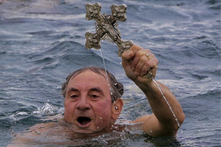 Orthodox men dive for cross in Istanbul's waters | Living ...