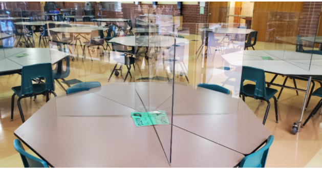 LPS installing plastic barriers on lunch tables for more protection