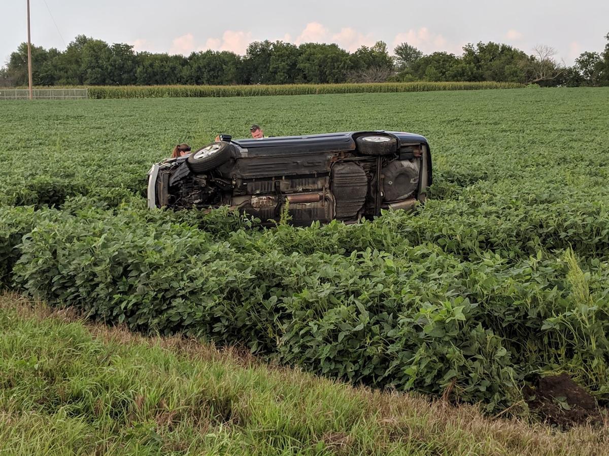 Woman taken to hospital after car flips into soybean field
