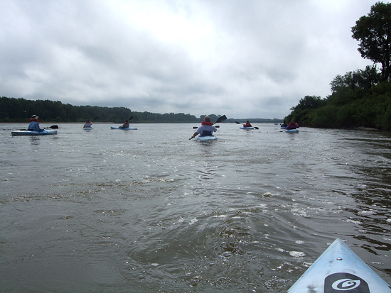 Kayakers paddle on the Platte River to get a closer view