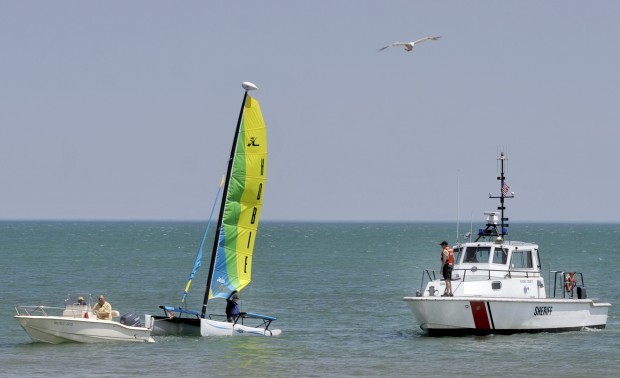 Boaters helped after catamaran overturns