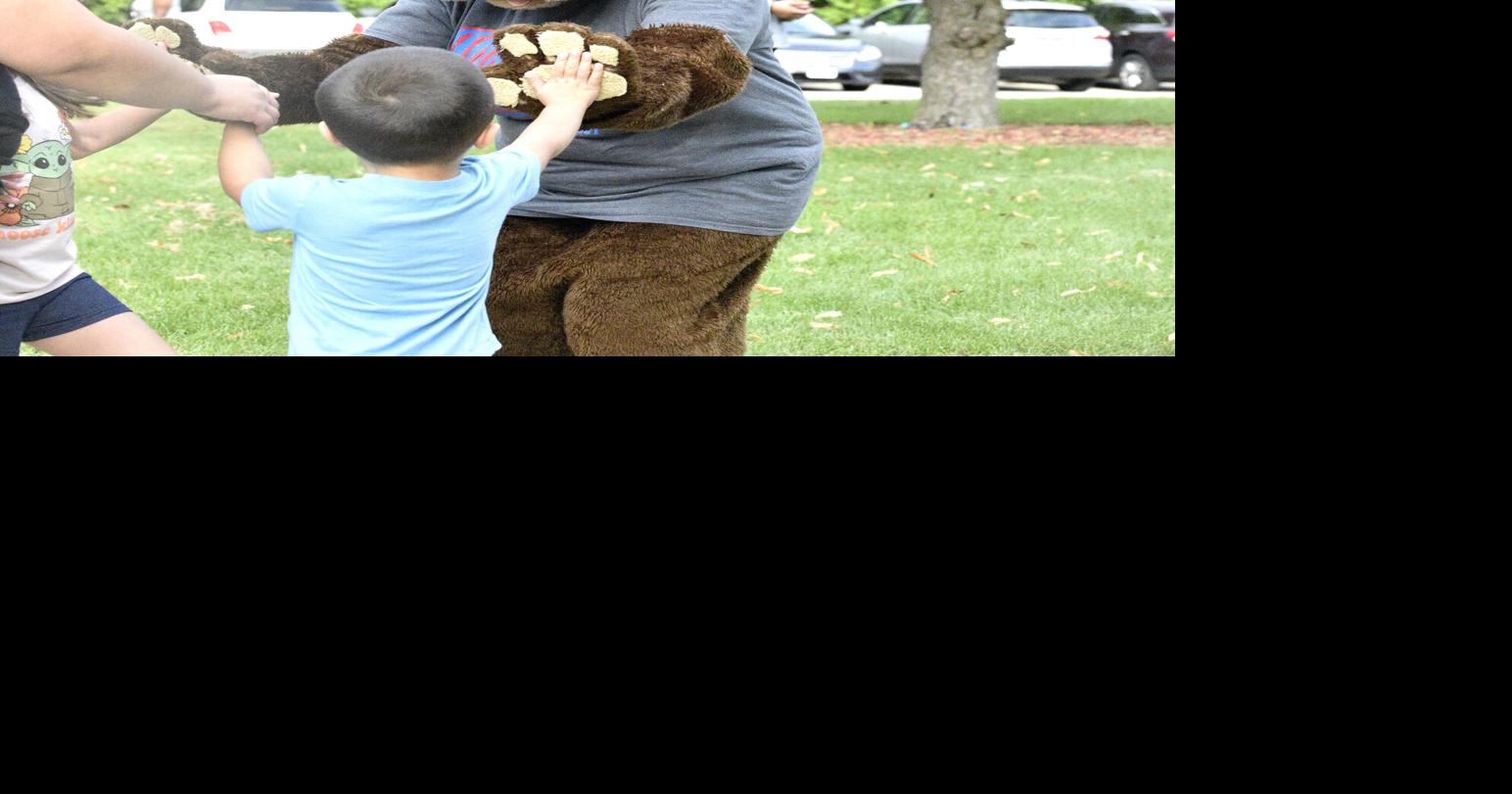 Bear and student high-five