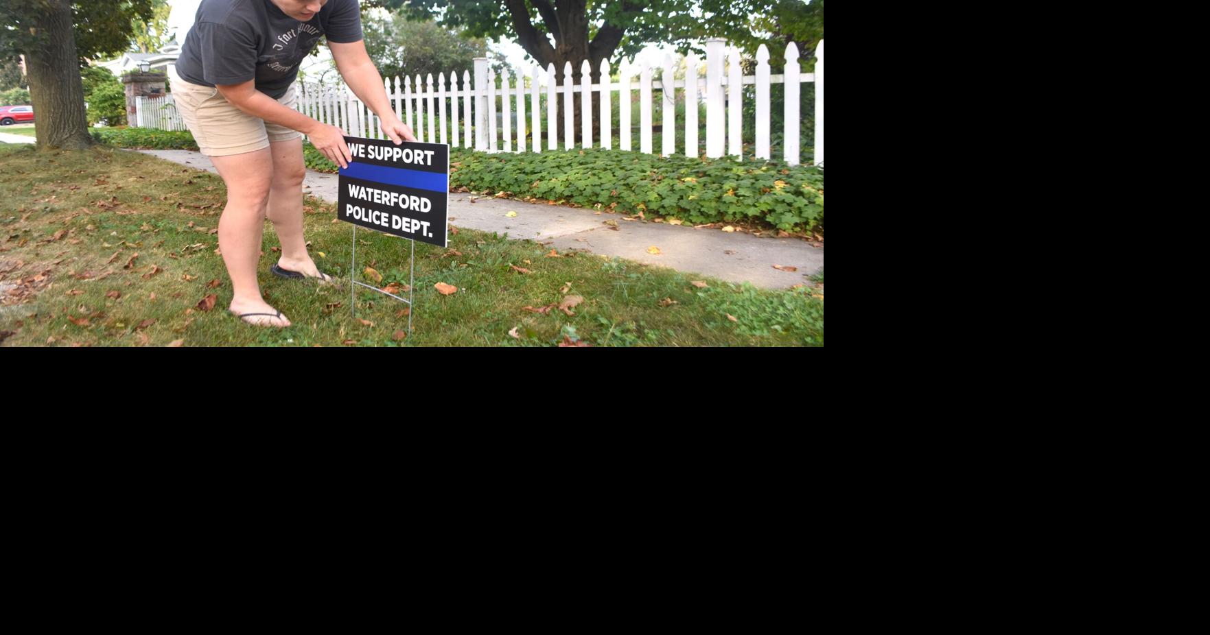 Village president sends a message with police yard signs